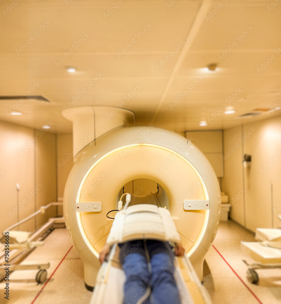 A patient lies down comfortably on the MRI scanner, undergoing a relaxing MRI scan to assess the ...