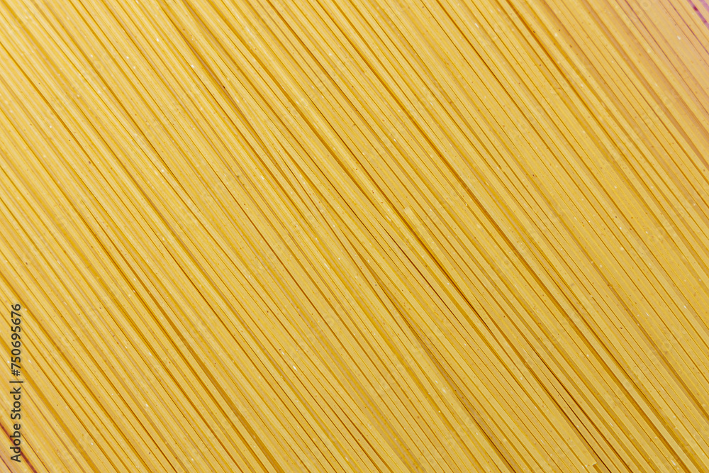 Yellow long spaghetti on a rustic background. Yellow italian pasta ...