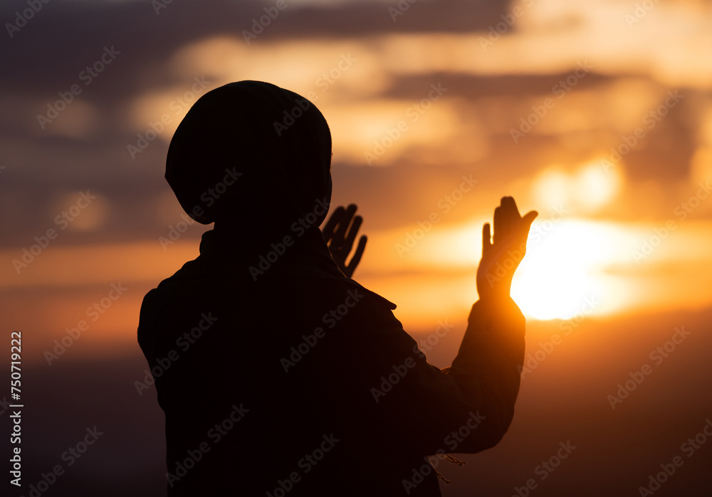 Muslim woman prayer praying with hands up open doing dua at sunset ...