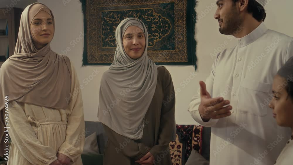 Medium footage of two young muslim women covered with hijab and wearing ...