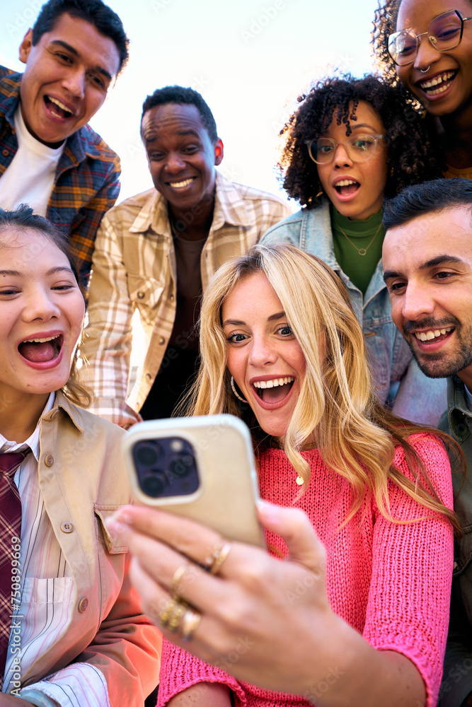 Vertical photo. A group of happy amazed humans friends in outerwear ...