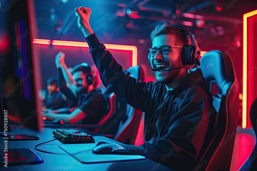 group of happy male cyber sport gamers raising hand, celebrating ...