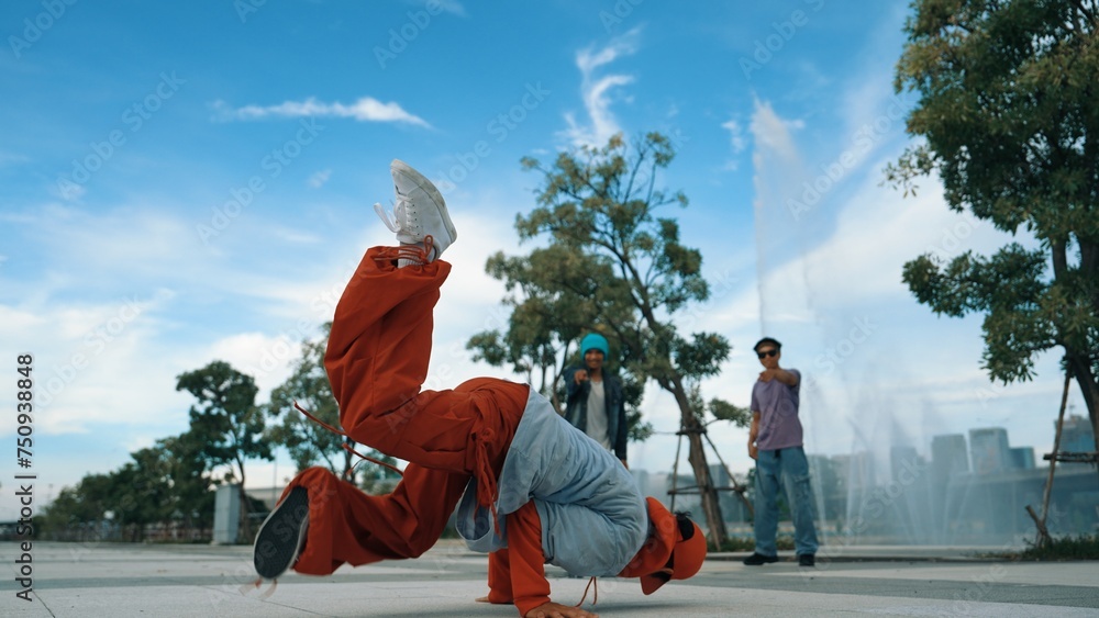 Asian skilled hipster doing freeze pose at camera surrounded by break ...