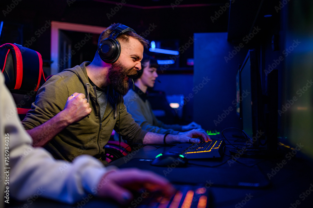 Bearded man gamer celebrating success and victory while playing video ...
