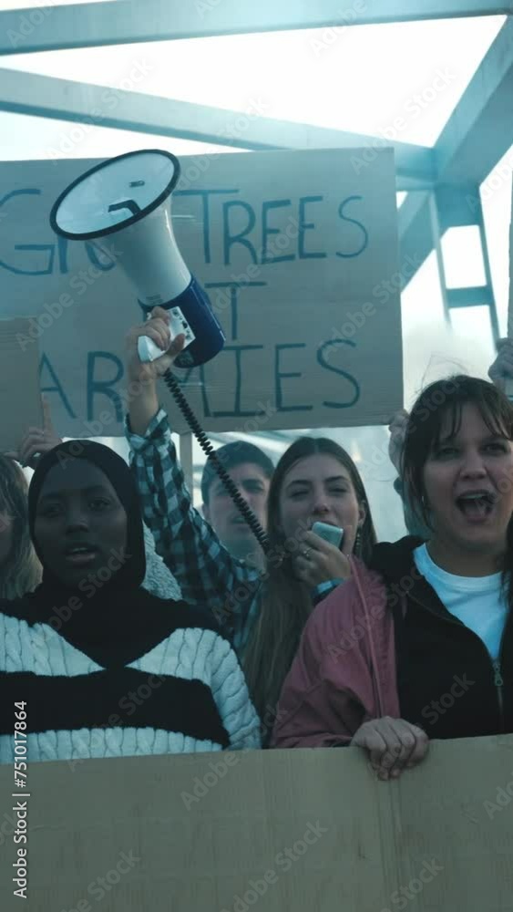 Vertical blonde woman with megaphone in protest diverse group activist ...
