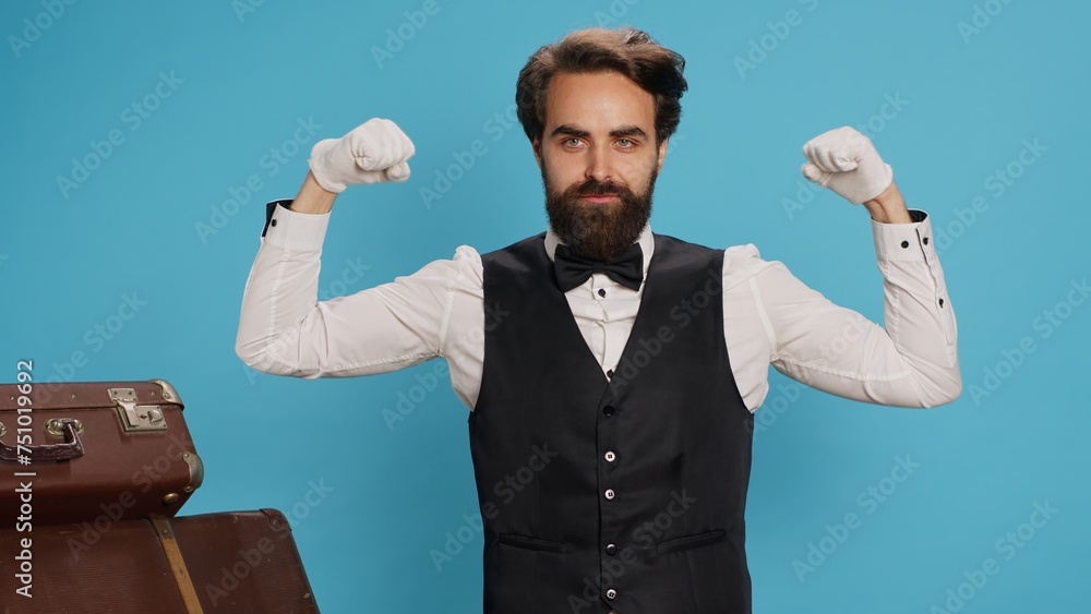 Strong employee flexing arm muscles in studio, indicating power and ...