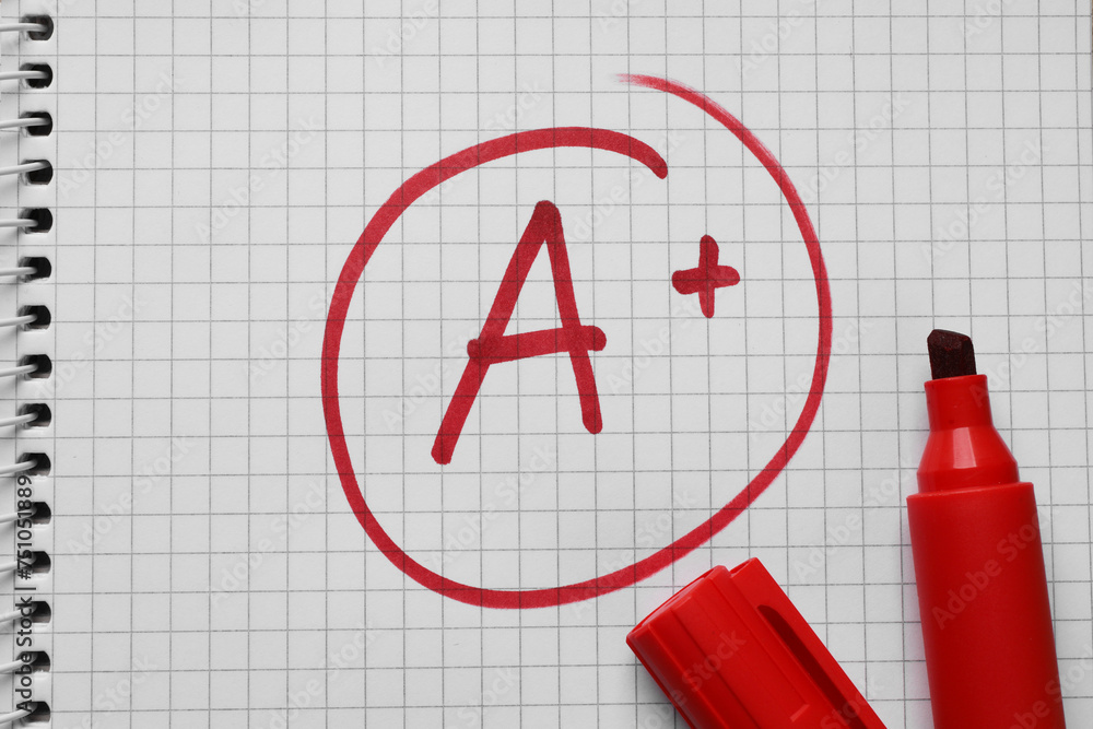 School grade. Red letter A with plus symbol on notebook paper and ...
