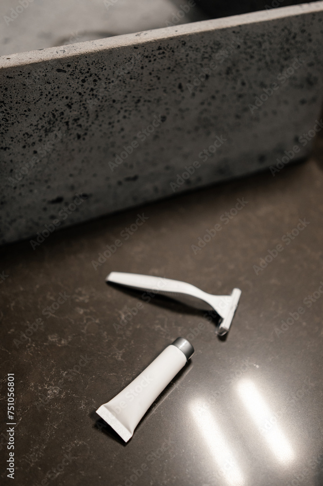 disposable plastic razor and toothpaste on bathroom vanity Stock Photo ...