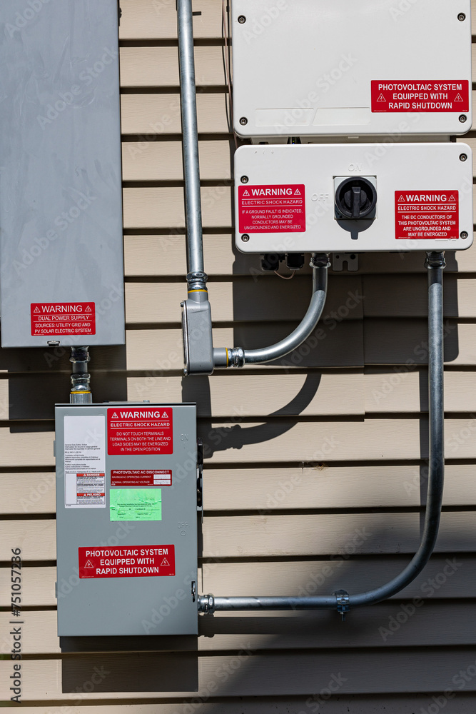 The exterior of the house features a photovoltaic system inverter, a ...