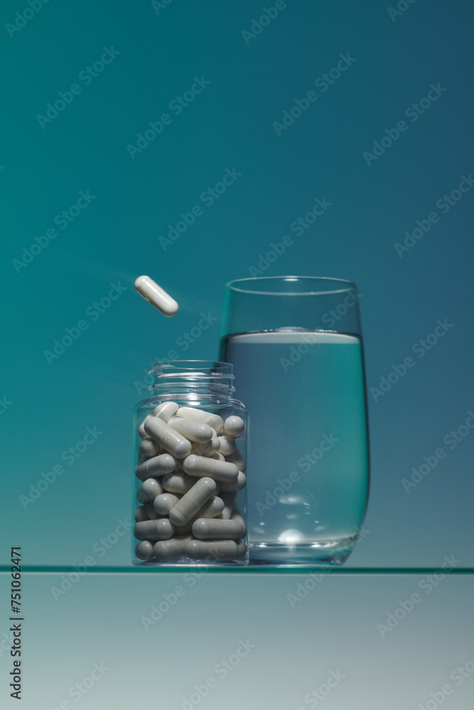 White pillare flying out of the glass jar near a glass of water Stock ...