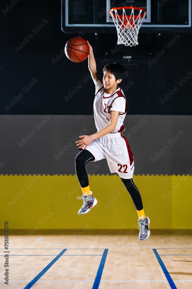 Teenage basketball girl slam dunking balls in school gym Stock Photo ...