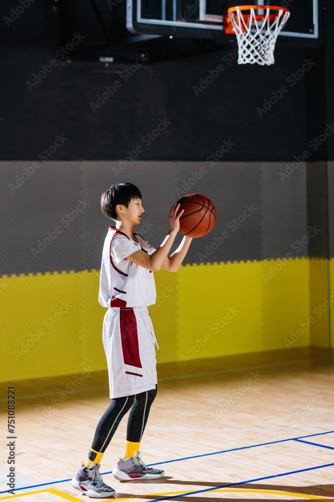 Teenage basketball girl slam dunking balls in school gym Stock Photo ...