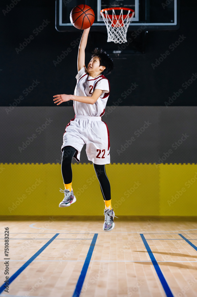 Teenage basketball girl slam dunking balls in school gym Stock Photo ...