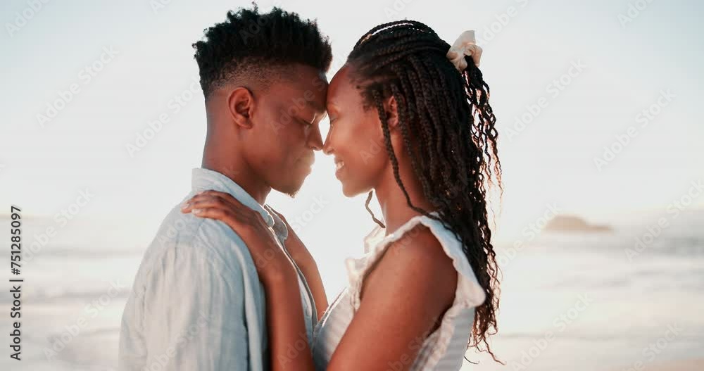 Couple, romance and happy with sunrise at beach for affection, commitment and bonding on ...