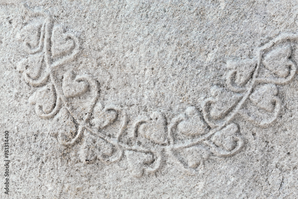 Ancient stone relief showcasing intricate vine scroll patterns, typical ...