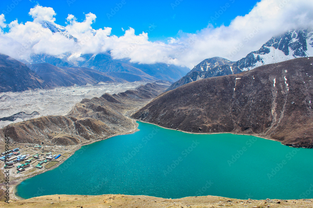 Gokyo Tsho or Dudh Pokhari is an emerald green high altitude Himalayan ...