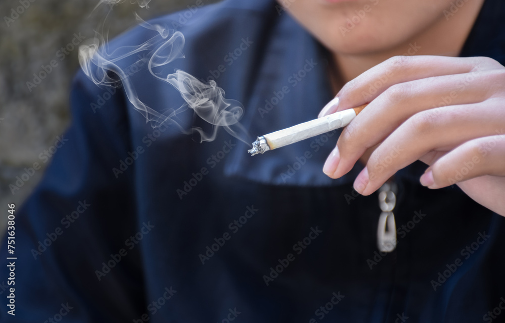 Closeup hand holding lighted cigarrette in private area of asian ...