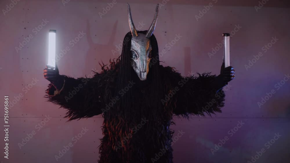 Video „The devil monster dances with RGB sticks in his hands. A ...