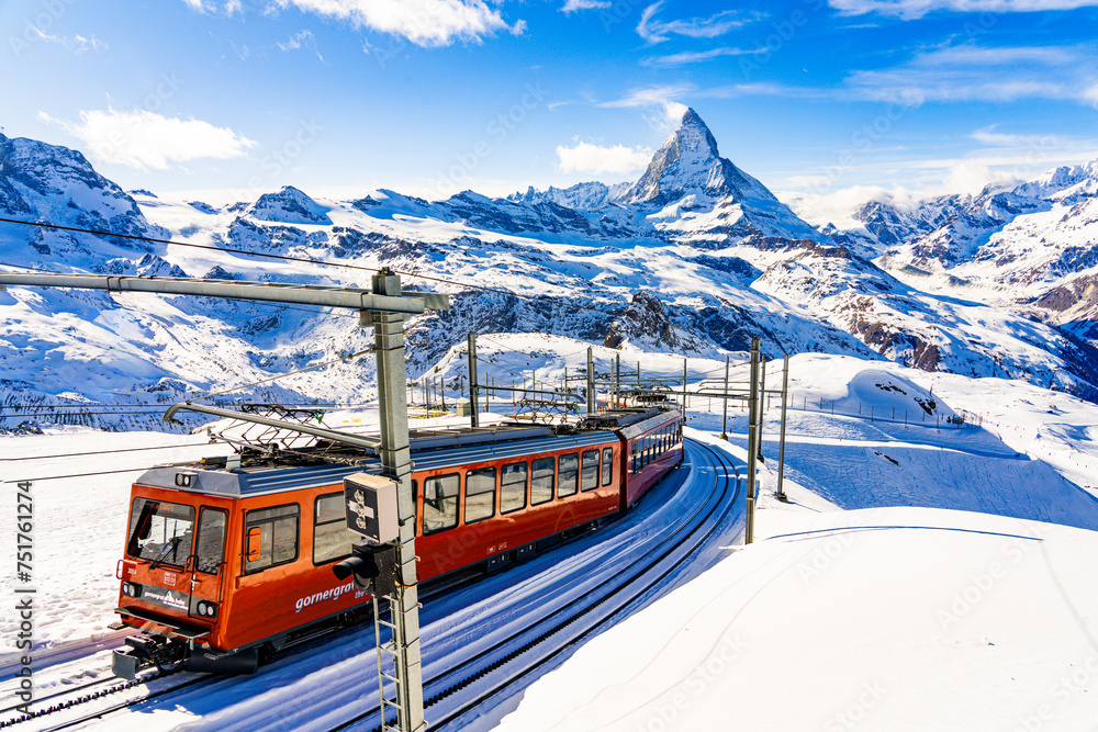 Cogwheel train of the Gornergrat Railway climbing the mountain facing ...