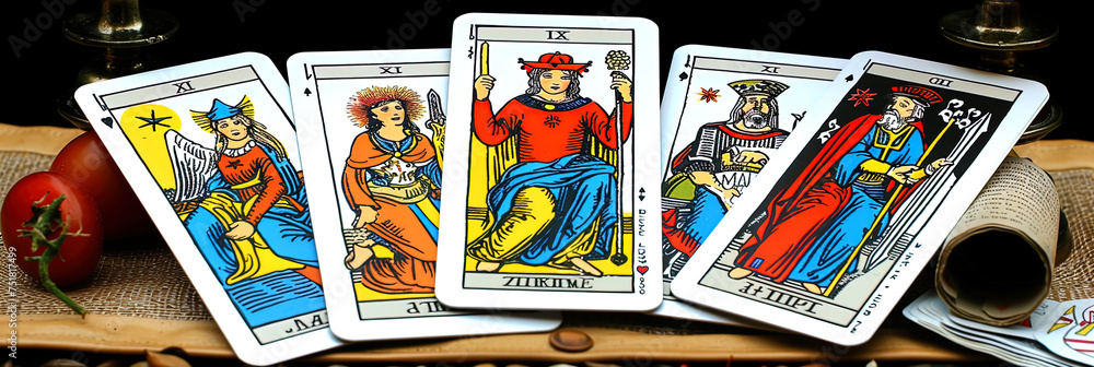 Tarot cards laid out on a table with an antique coating surrounded by ...