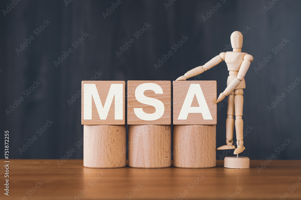 There is wood cube with the word MSA. It is an abbreviation for Master ...
