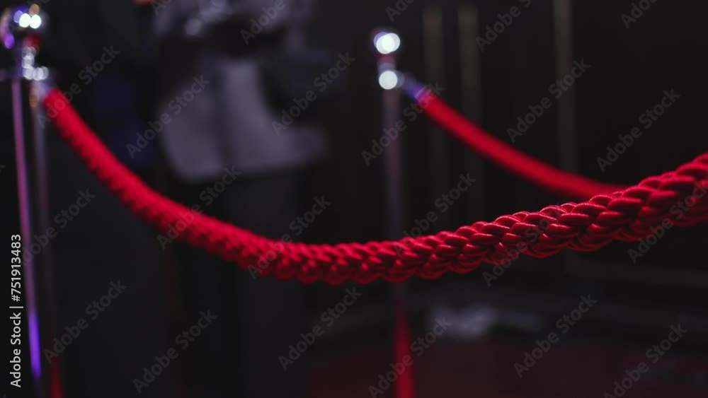 Red carpet with ropes and golden barriers on a luxury party entrance ...