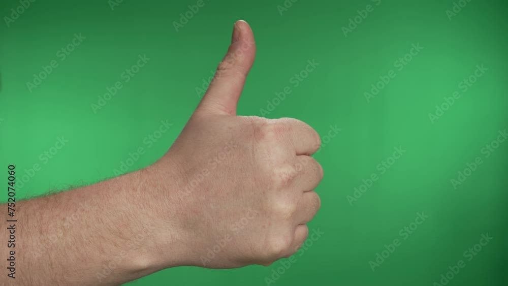 adult man hand show thumb up gesture. hand gestures on green background ...