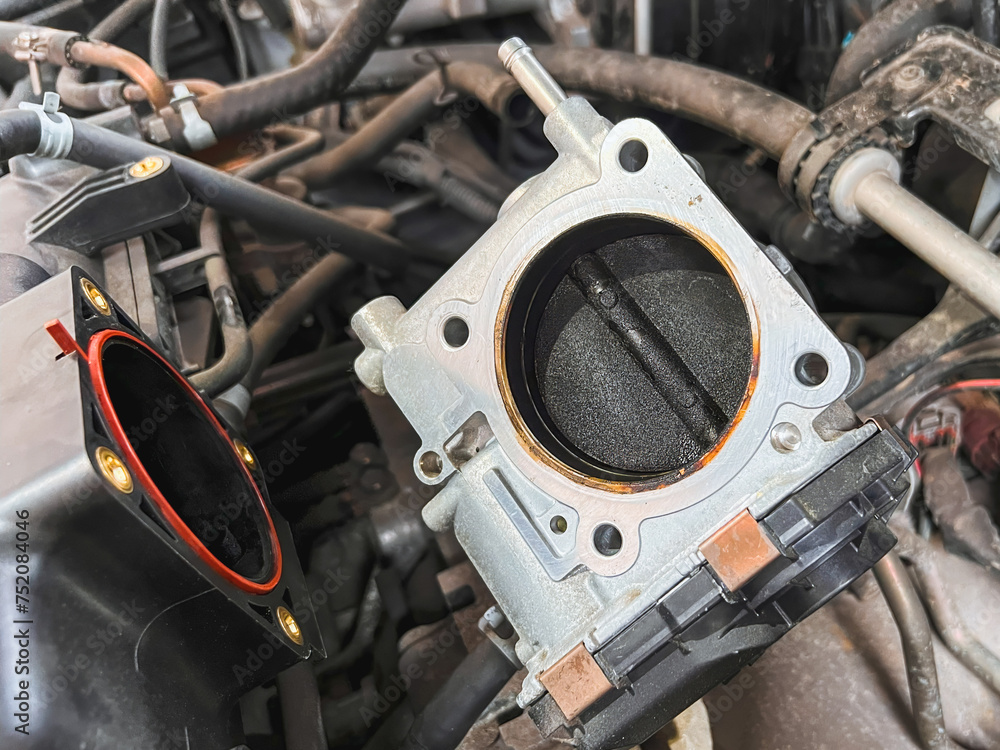carbon deposits damage a throttle valve of a car engine. The valve ...