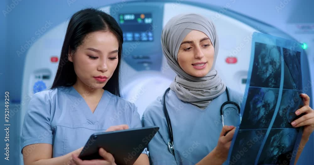 Doctor in hijab looking at MRI image. Muslim doctor consulting with ...
