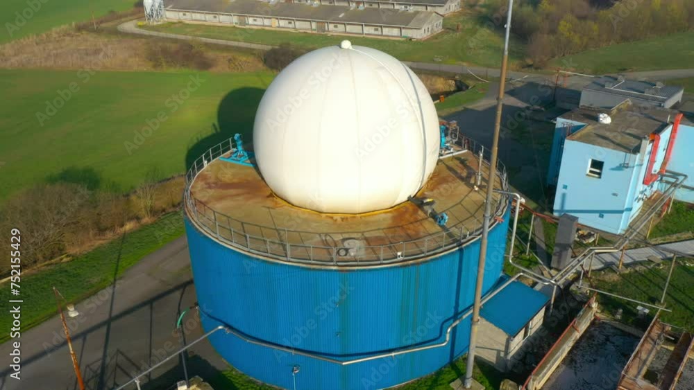 Biogas plant and farm in fields. Renewable energy from biomass. Agriculture prepared for Green ...