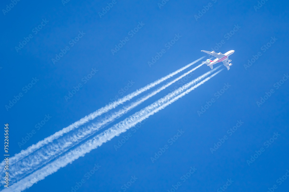 Emirates Airbus A380-800 airplane with contrails over Munich Airport in ...