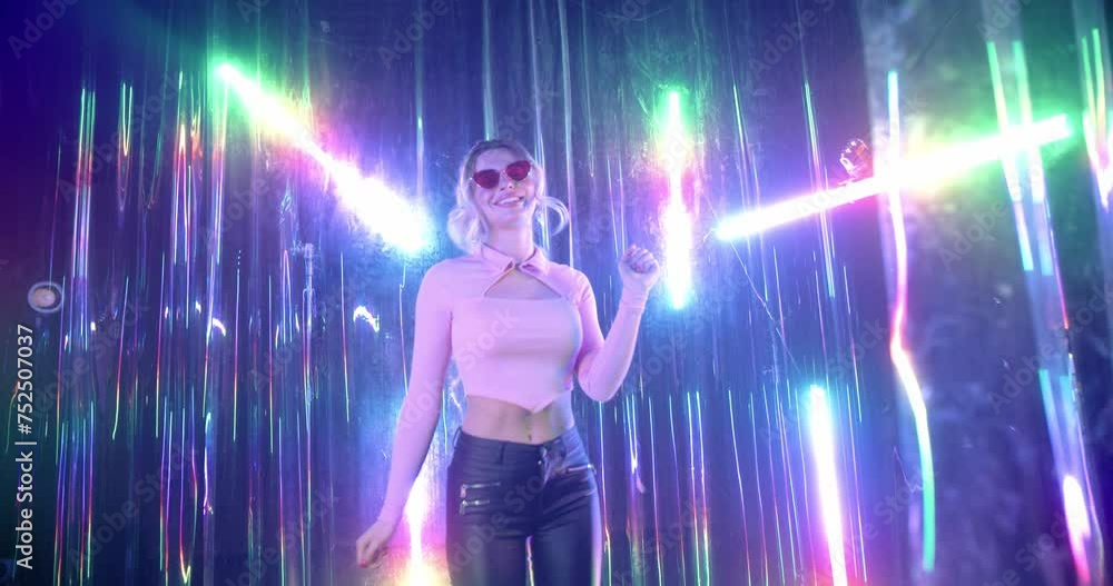 Rainbow light. Woman dancing at background of neon illumination. Female ...