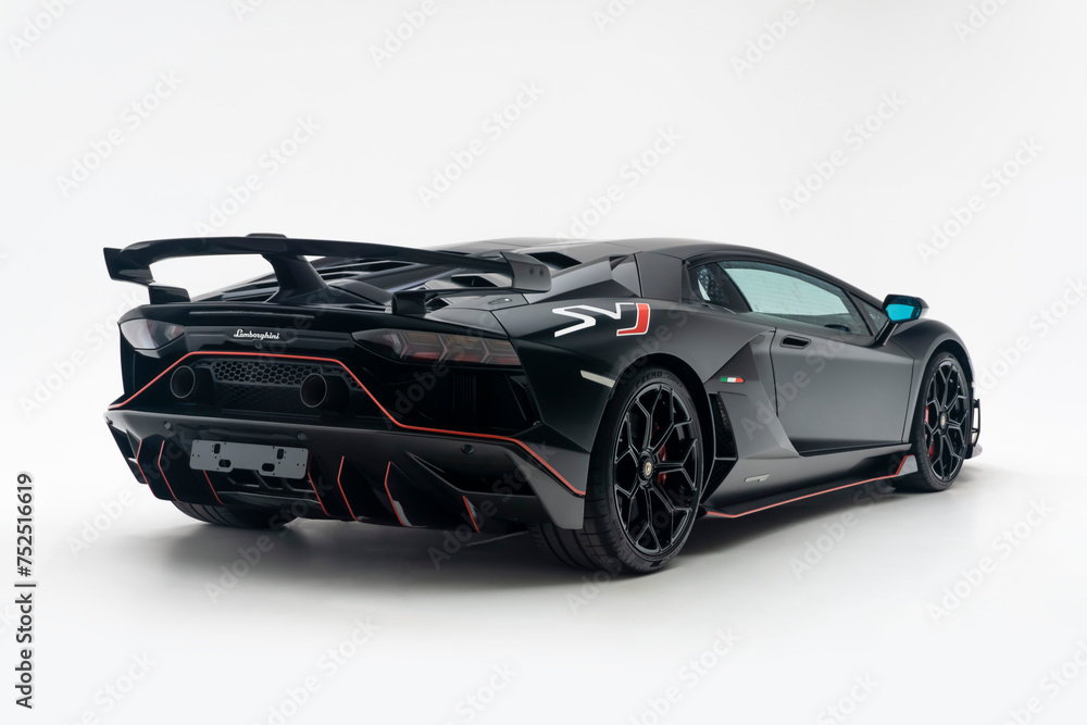 Rear end three quarters view of a matte black Lamborghini Aventador SVJ ...