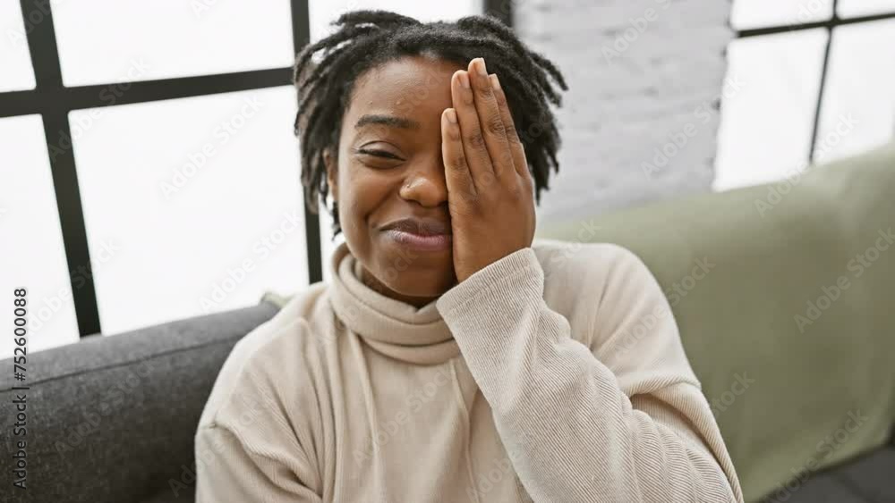 Chilled-out young black woman with dreadlocks, sitting comfy on her ...