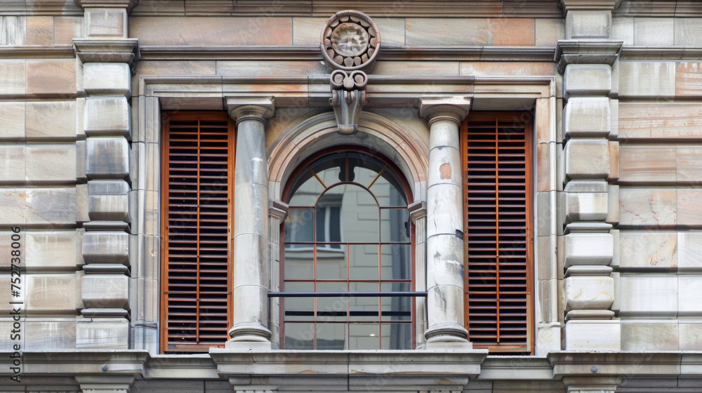 A small circular window with a scalloped frame nestled above a larger ...