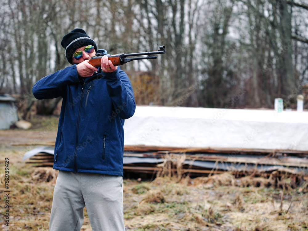 Man with old style rifle with wooden base and stock and simple iron ...
