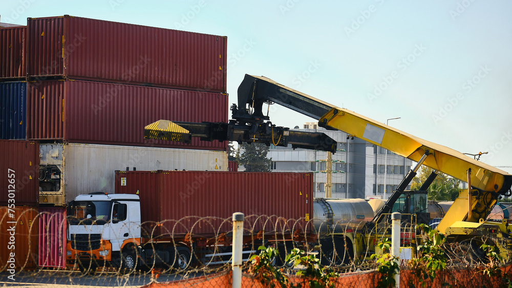 Unloading of cargo container. Reach-stacker is ready to pick container ...