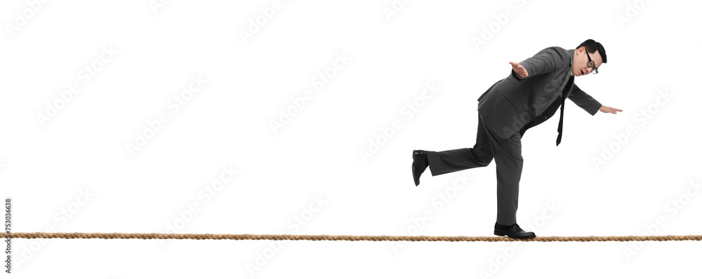 Risks and challenges of owning business. Man balancing on rope against ...
