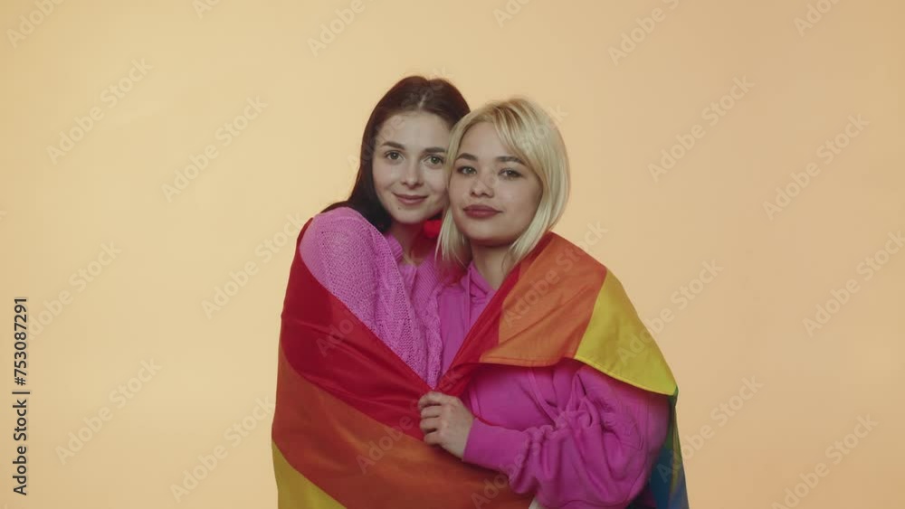 Couple Young Lesbians Girls Hugging Happily And Wrapped With Rainbow
