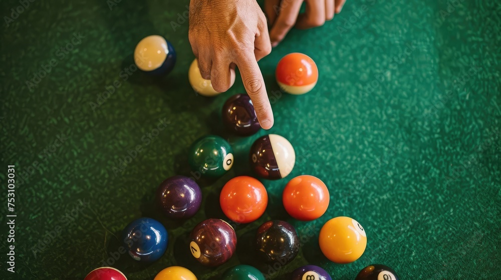 An overhead view of a player lining up a shot on a billiard table, with ...