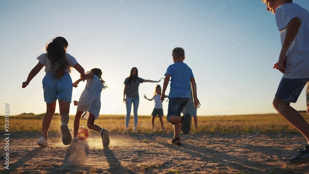 happy family playing ball in the park. a group of children playing ball in nature. happy family ...