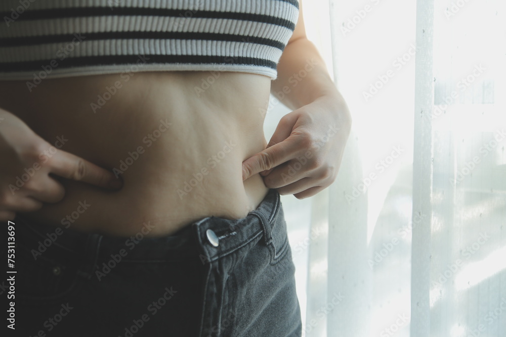 Women body fat belly. Obese woman hand holding excessive belly fat ...