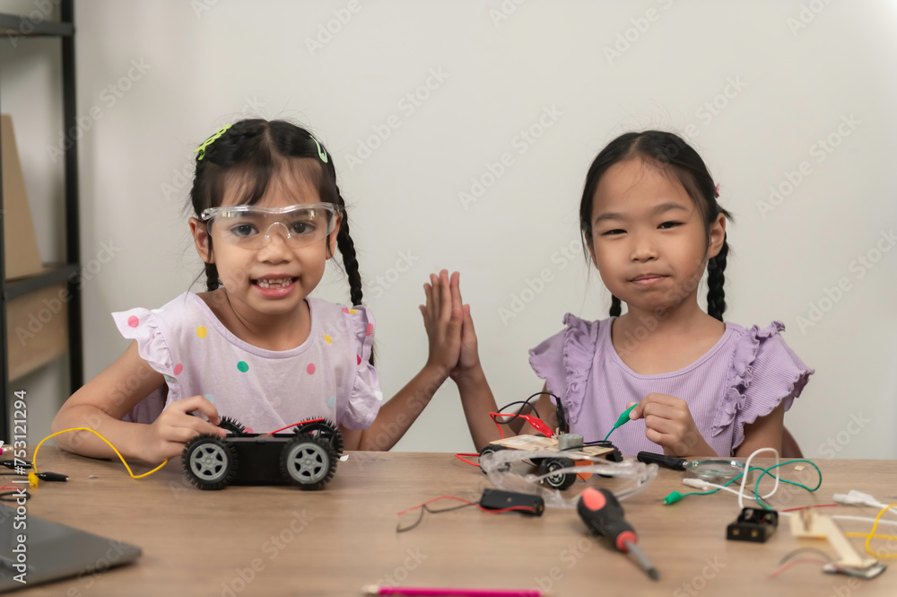 Asian littlle girl constructing and coding robot at STEM class,Fixing ...
