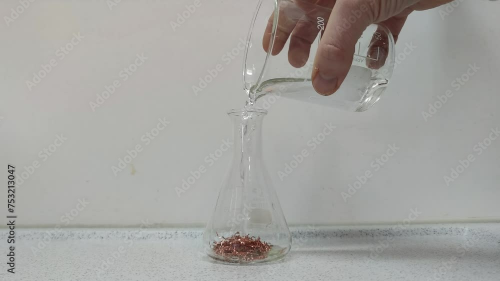 Chemical experiment in which Nitric acid (HNO3) is placed in an ...
