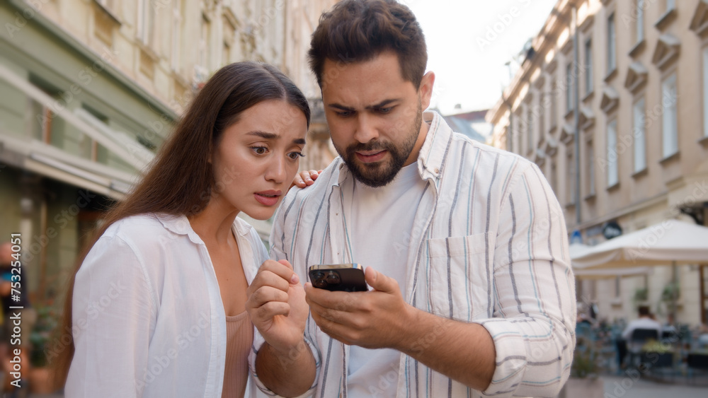 Caucasian young couple upset bad news mobile phone failure loss ...