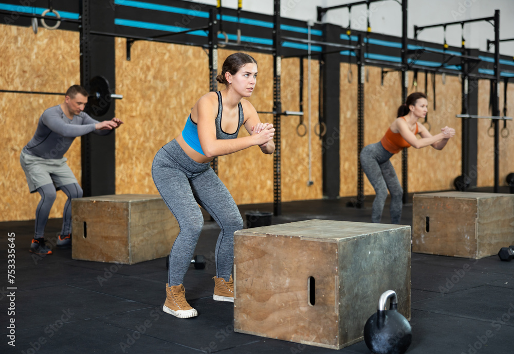 Girl performs exercises handstand push-ups, squats, hill climbing ...