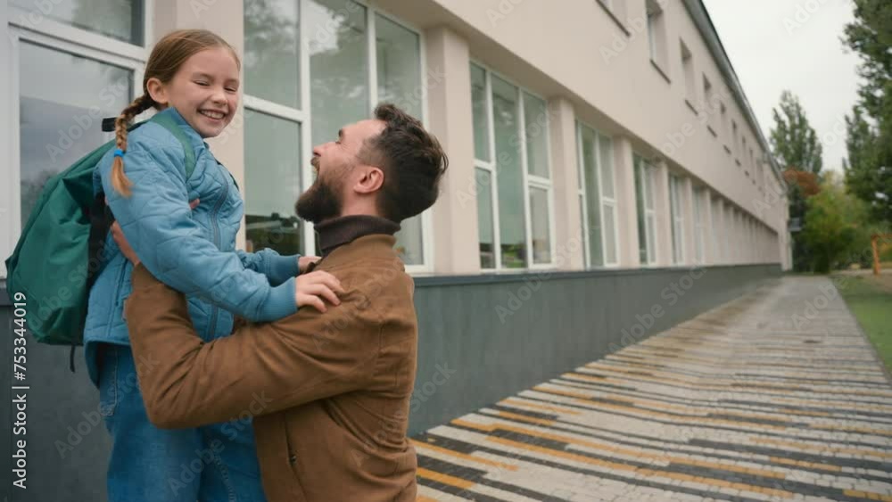 Daughter running to father. Happy family man lift girl primary school ...