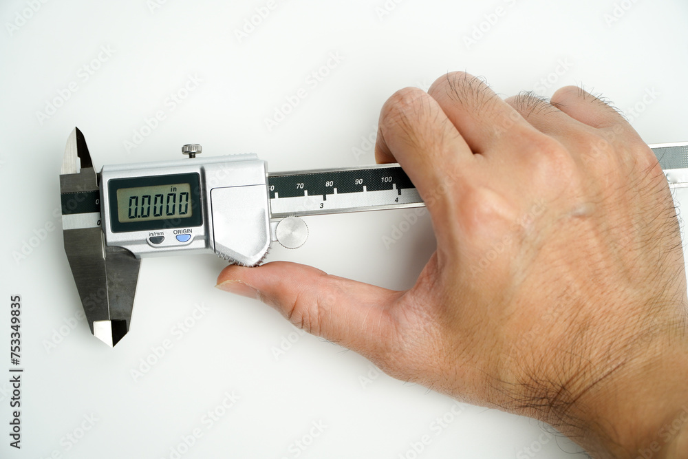 Male hand holding an electronic vernier caliper, sometimes known as a ...