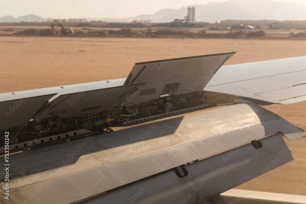 The plane lands on the airfield. Spoilers and flaps trailing edge when ...