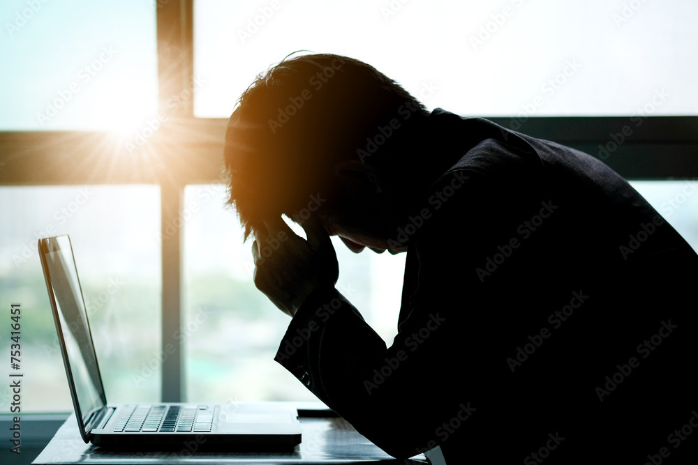 Man sitting down, his face unsettled. At the computer desk he has ...